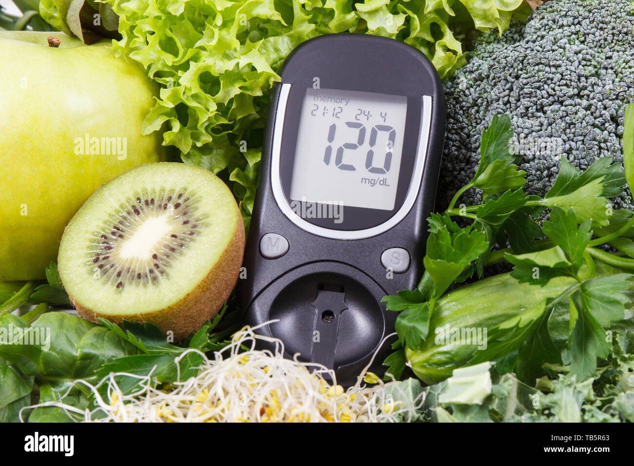 Glucometer for measuring sugar level and vegetables with sprouts as ...