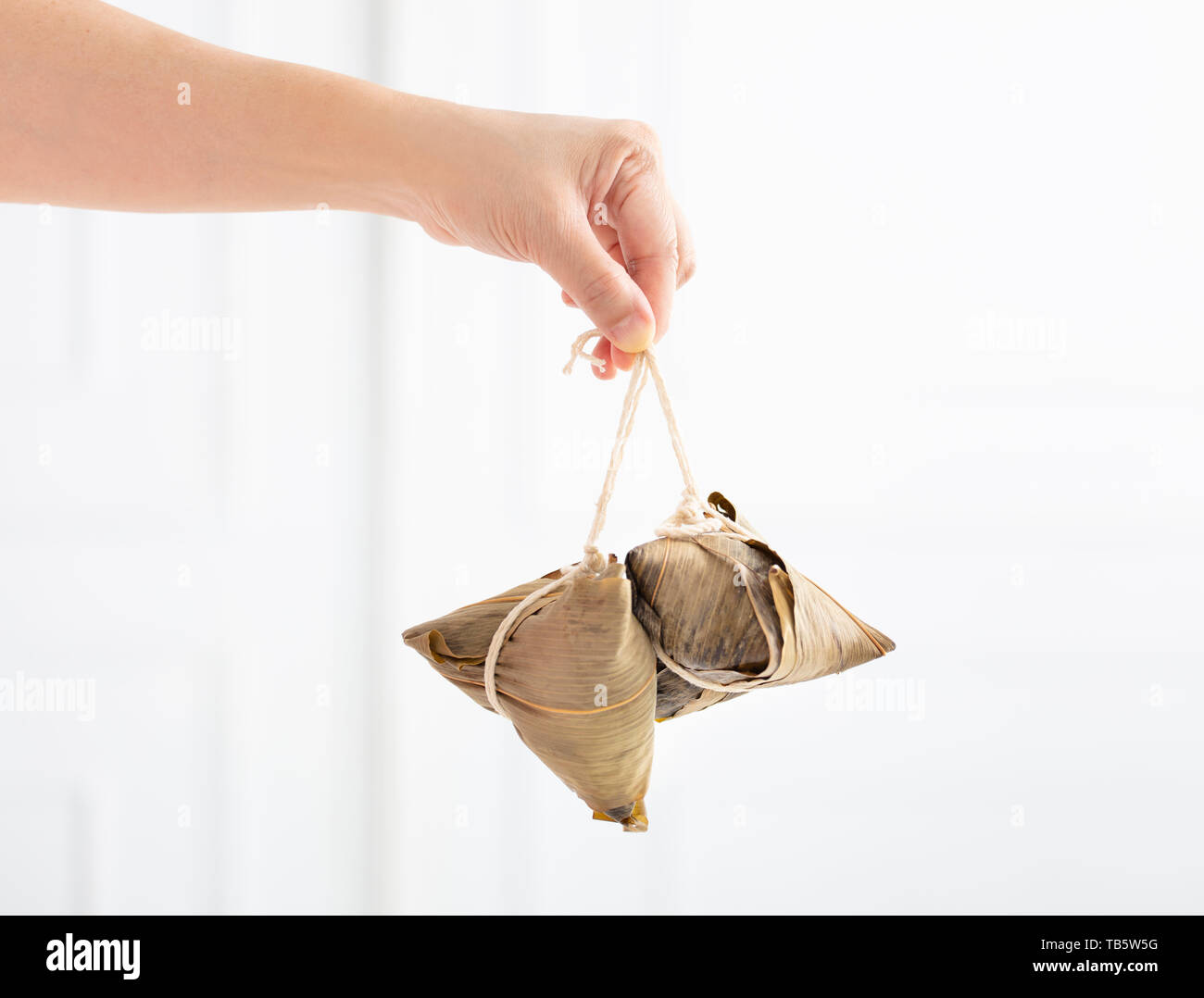 hand holding traditional chinese rice dumplings Stock Photo - Alamy