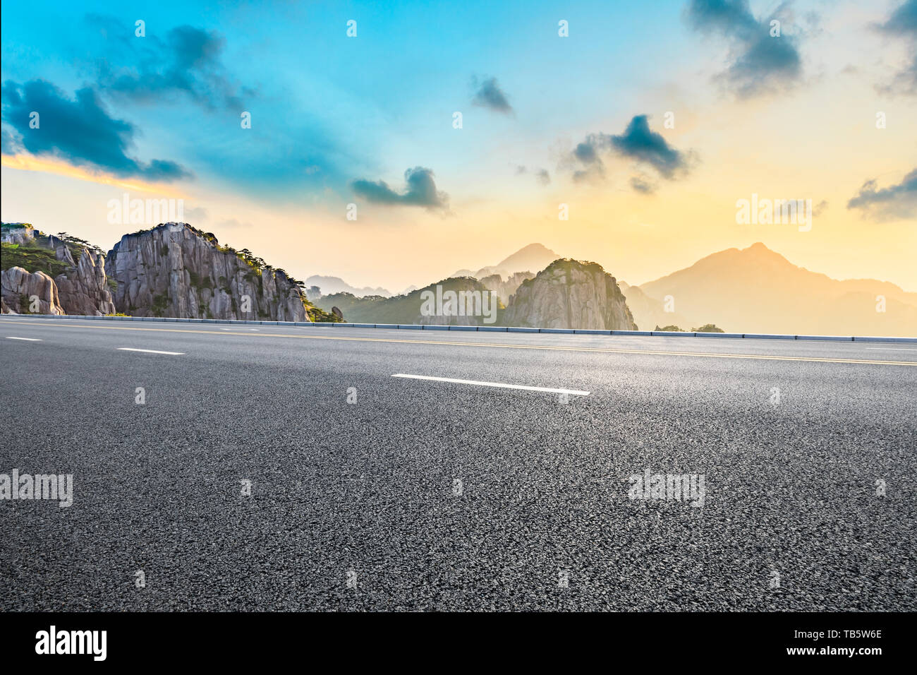 Asphalt highway road and beautiful huangshan mountains nature landscape ...