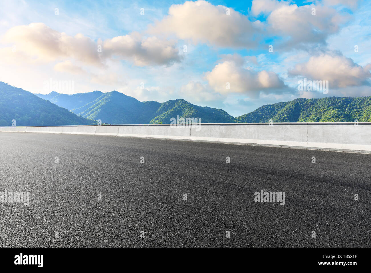 Empty highway road and beautiful mountain with clouds landscape Stock ...