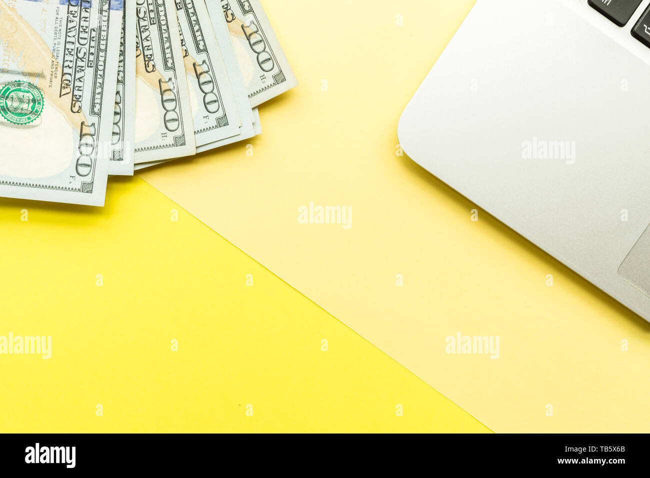 Laptop and cash money on yellow background. Top view with copy space ...
