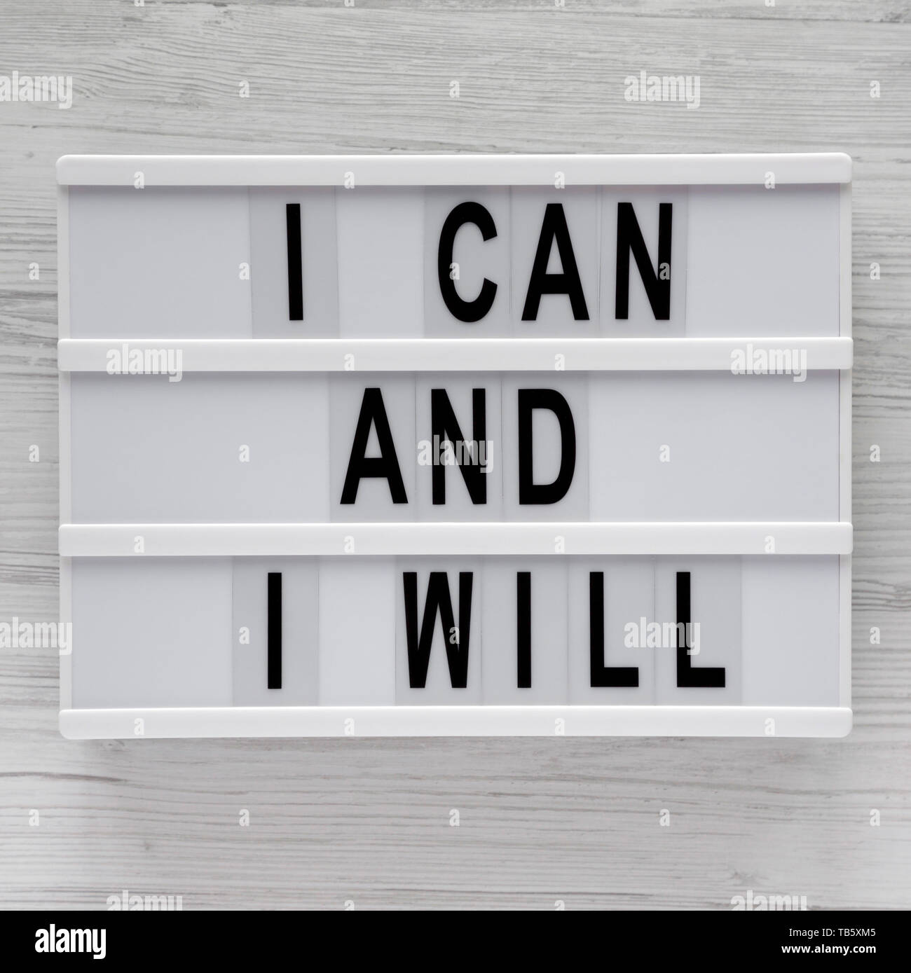 Modern board with 'I can and I will' words on a white wooden background ...