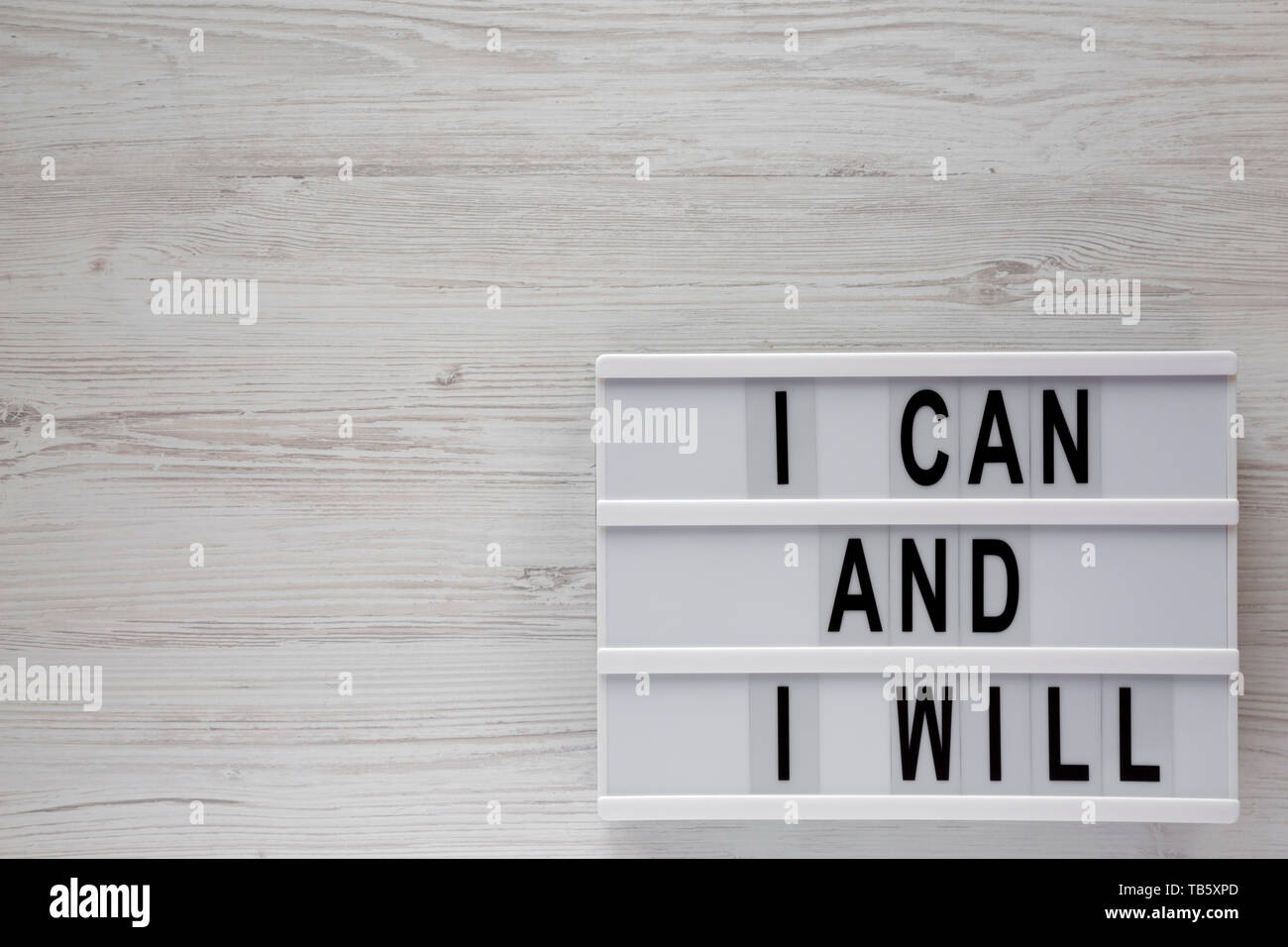 'I can and I will' words on a modern board on a white wooden surface ...
