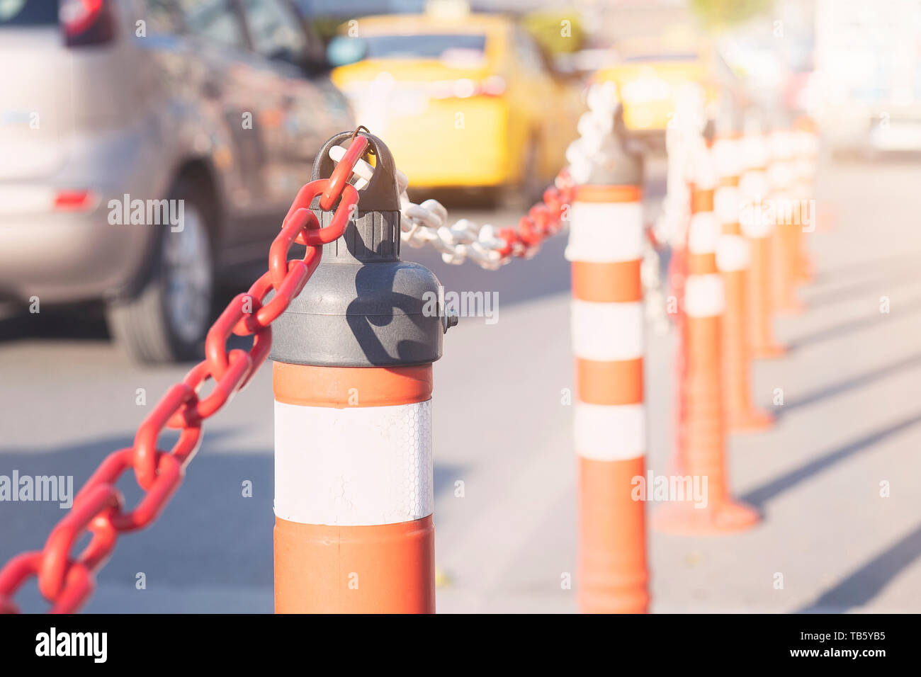 Traffic cones have a chain. Traffic pole white and red have chains ...