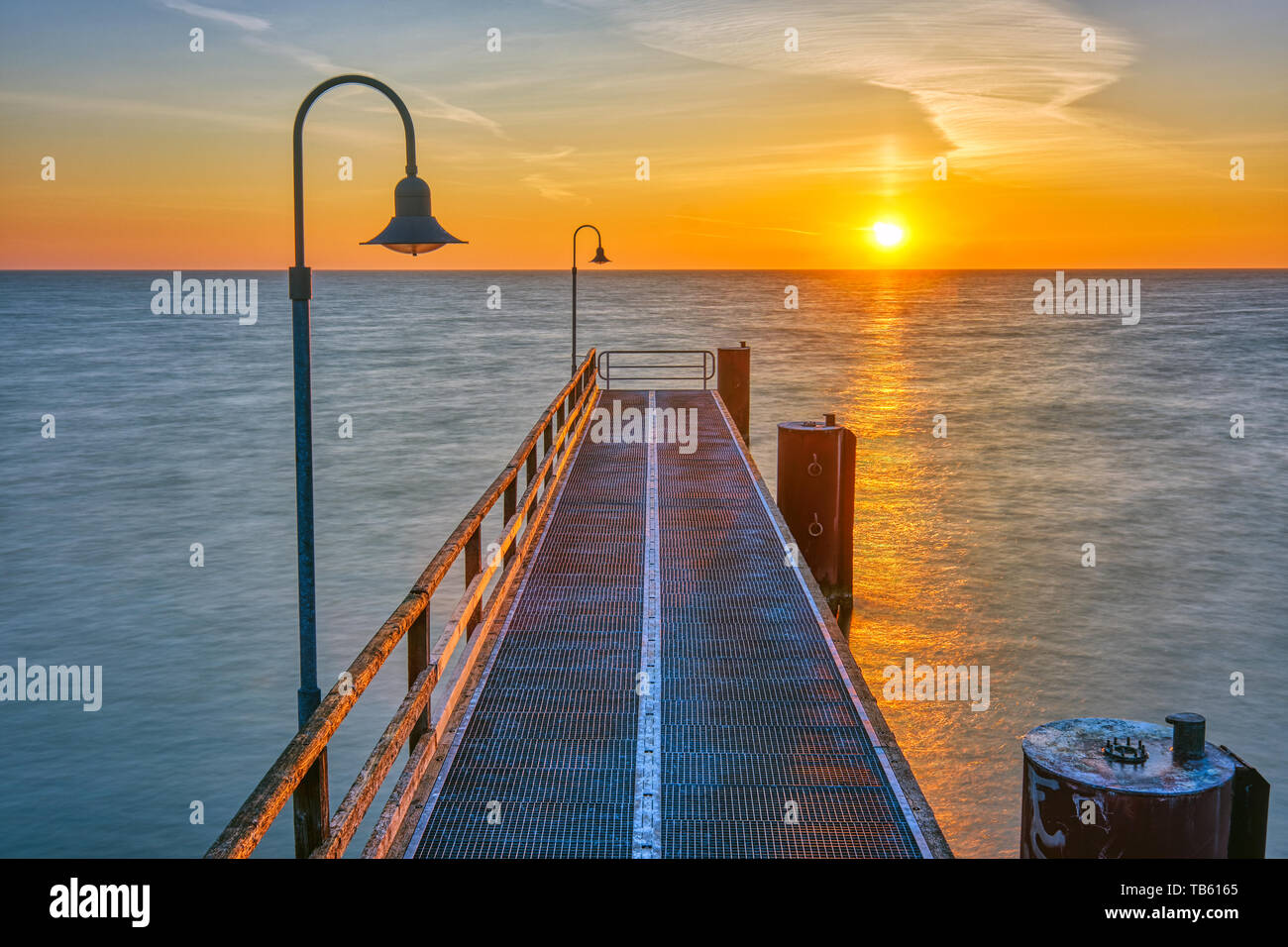 Pier at the german baltic sea coast at sunrise Stock Photo - Alamy