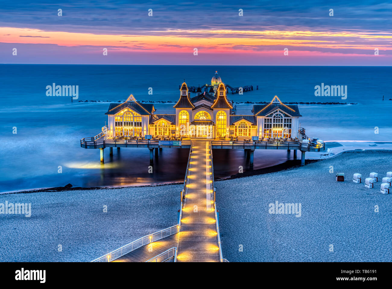Sea pier with restaurant before sunrise seen on Ruegen island, Germany ...