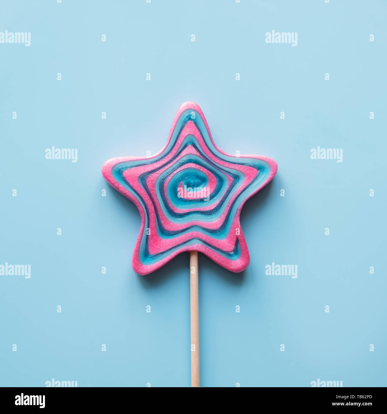 Lollipops swirl candy shaped as star on blue background. Top view ...