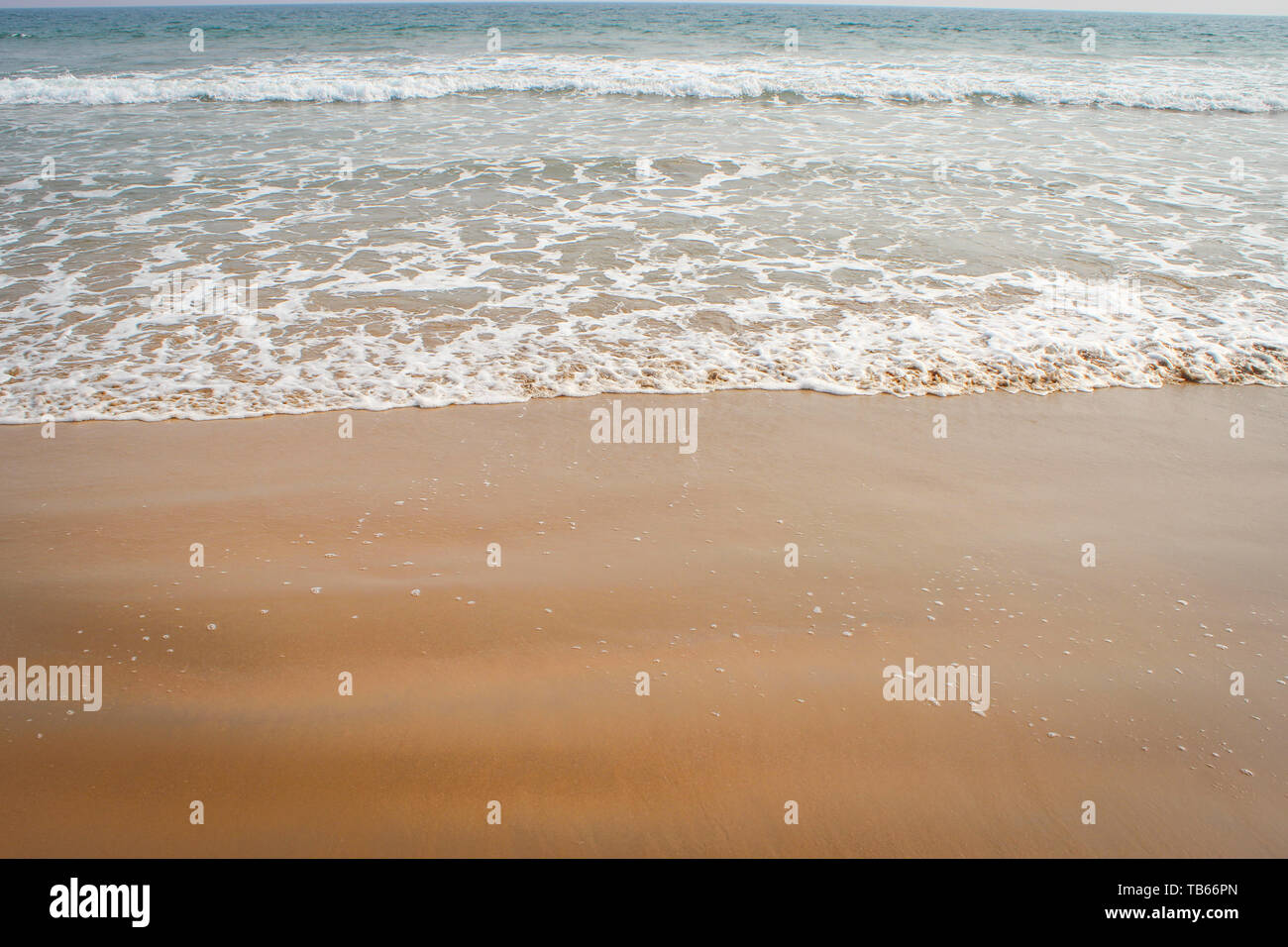 Turquoise blue sea waves on a sandy beach in Goa, India Stock Photo - Alamy