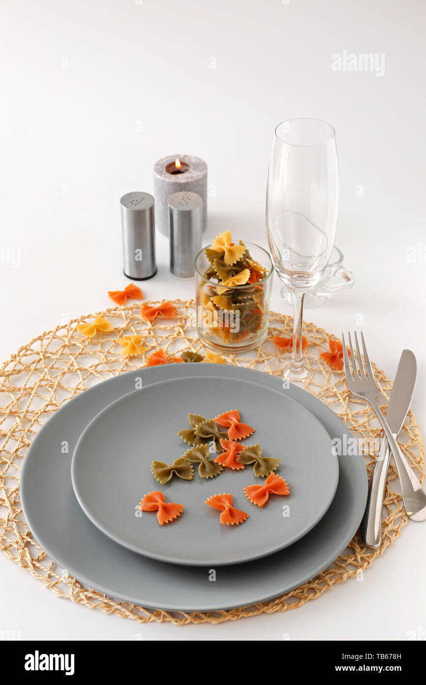 Beautiful table setting on light background Stock Photo - Alamy