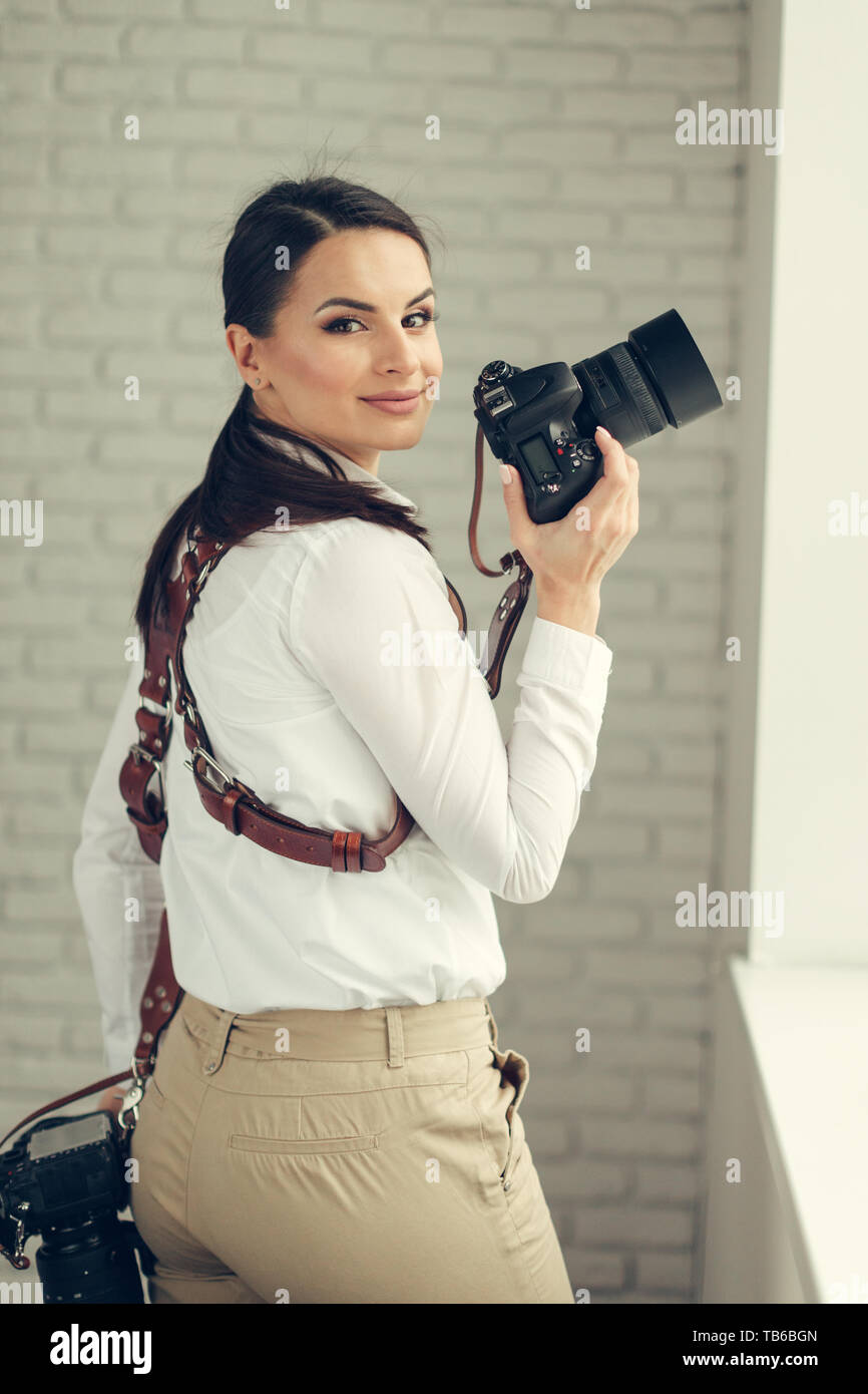 Pretty woman is a professional photographer with dslr camera Stock ...