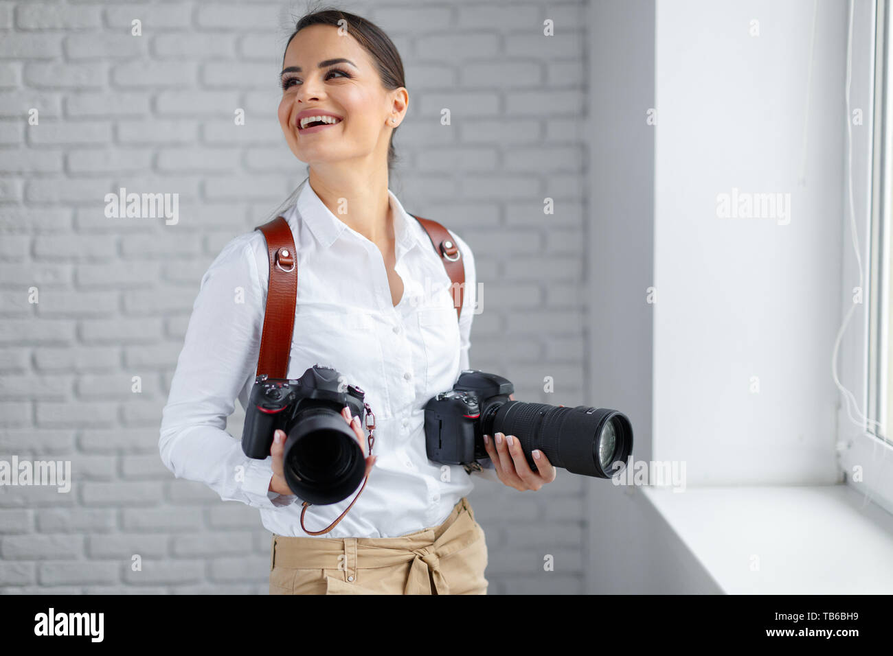 Pretty woman is a professional photographer with dslr camera Stock ...