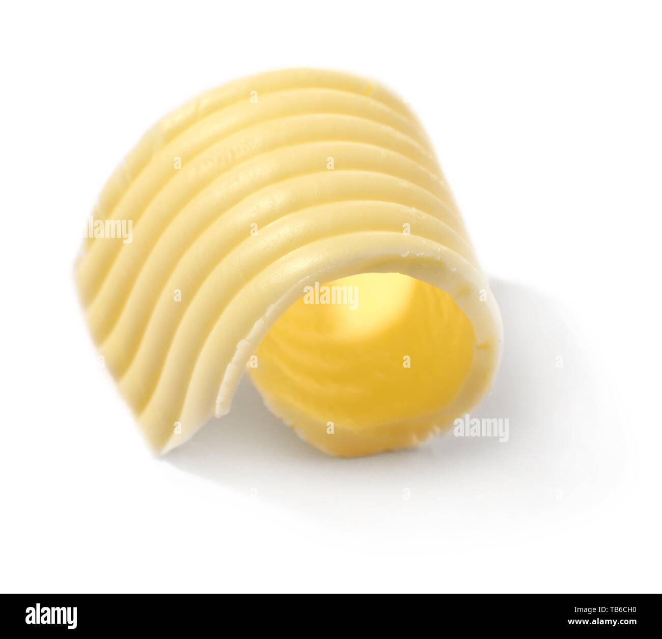 Butter curl on white background Stock Photo - Alamy