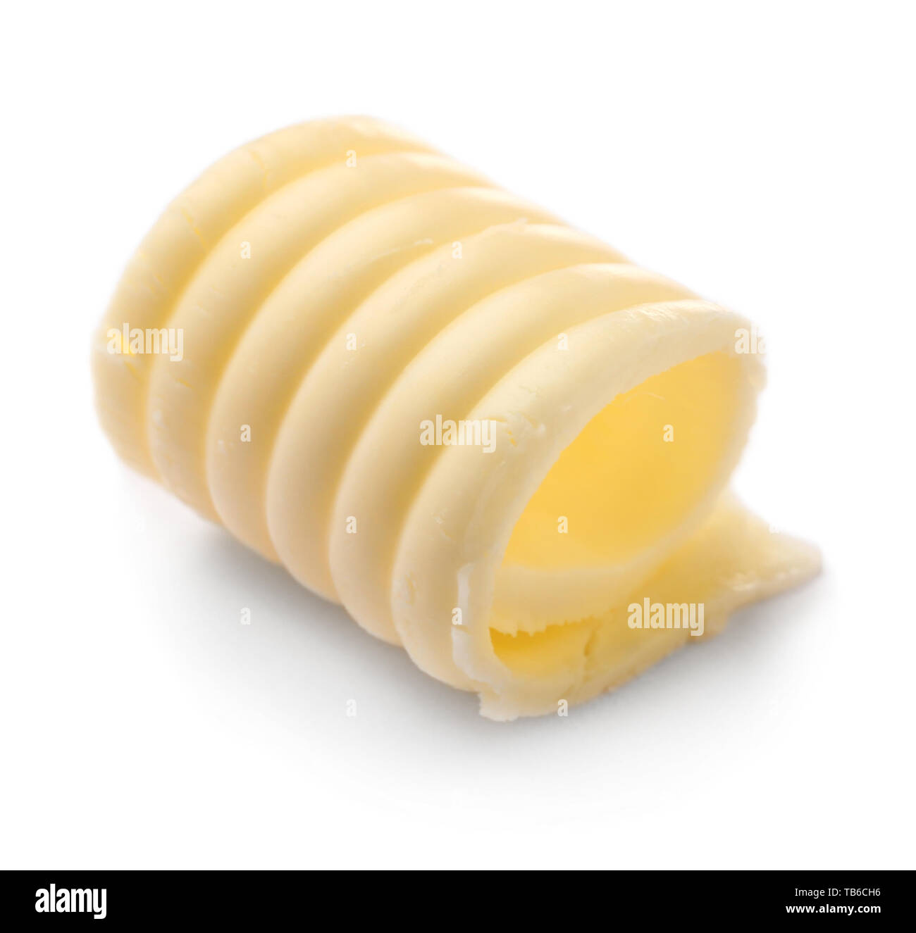 Butter curl on white background Stock Photo - Alamy
