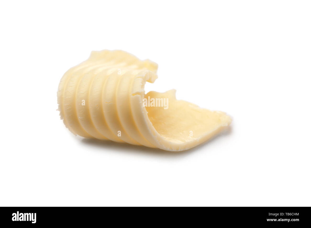 Butter curl on white background Stock Photo - Alamy