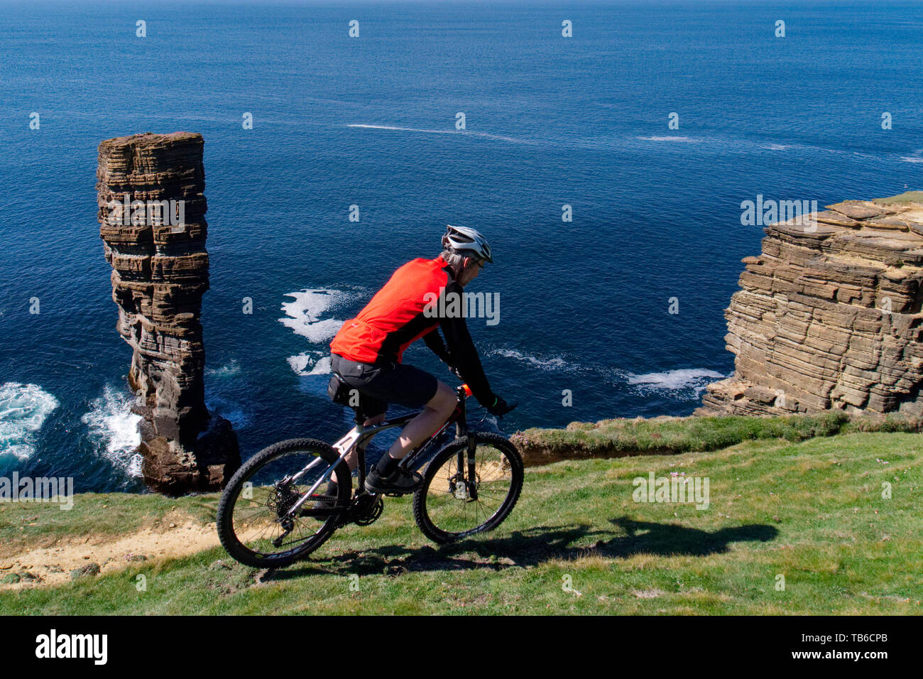 Mountain biking above the cliffs at North Gaulton, Orkney Mainland ...