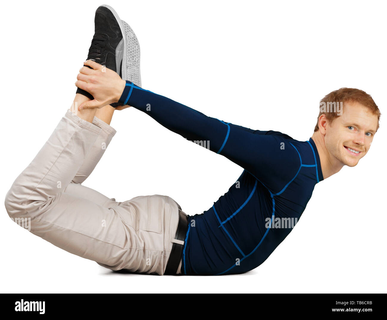 Flexible sporty young man doing stretching exercises isolated on white ...