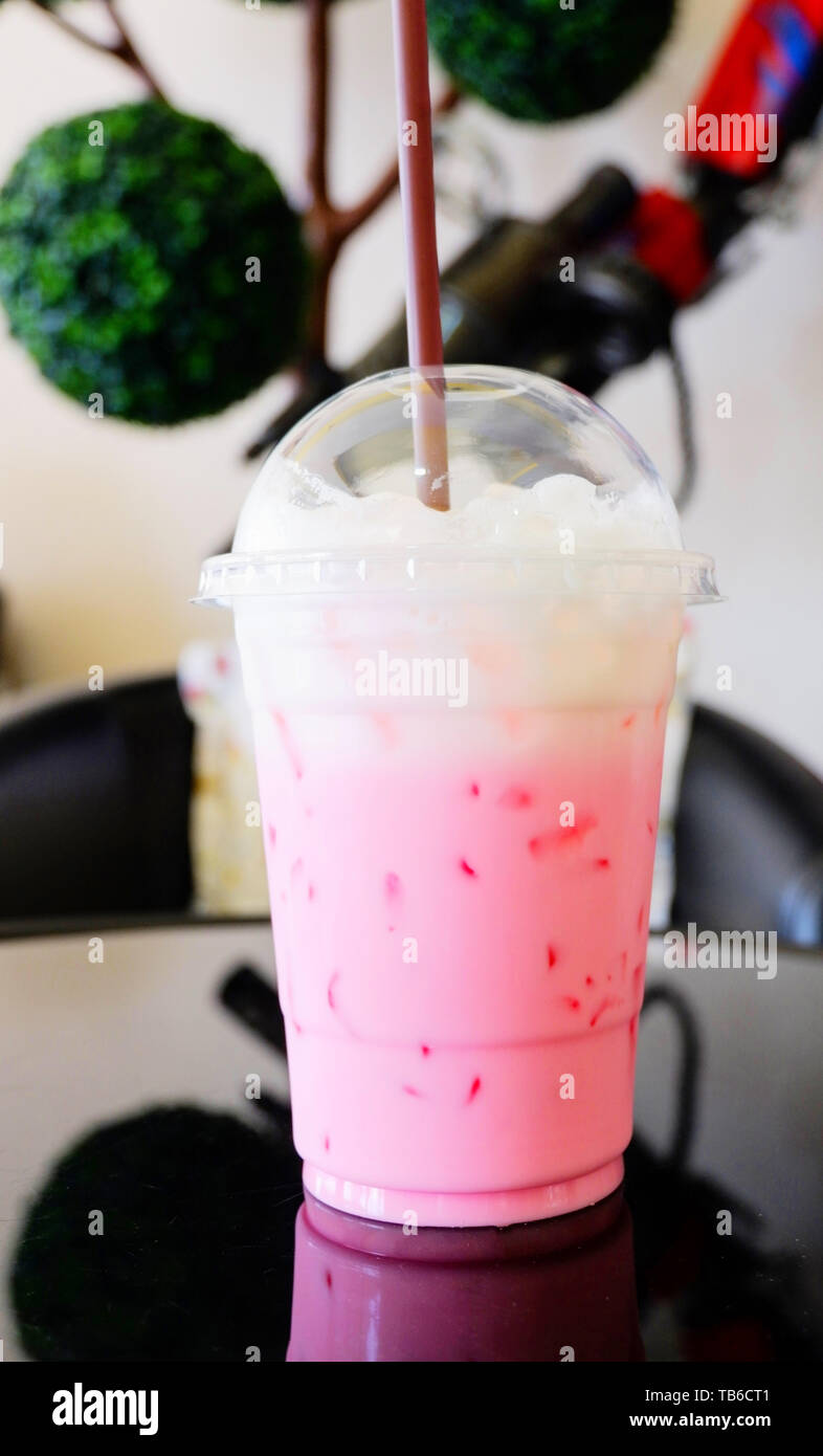Strawberry milk pink shake / Iced pink fresh milk in plastic cup and ...