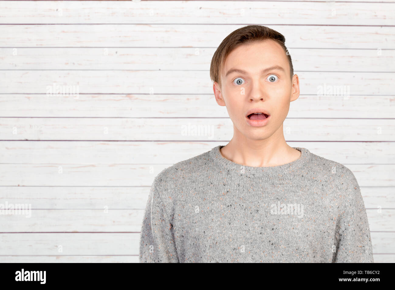 Portrait of young man with shocked facial expression Stock Photo - Alamy