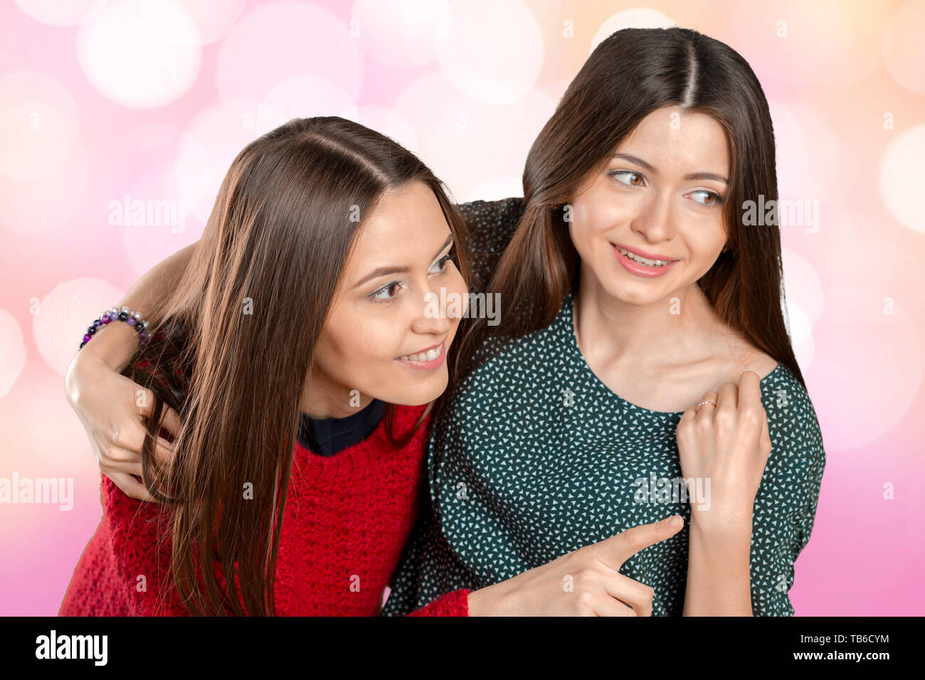 Two beautiful sisters hugging each other and smiling Stock Photo - Alamy