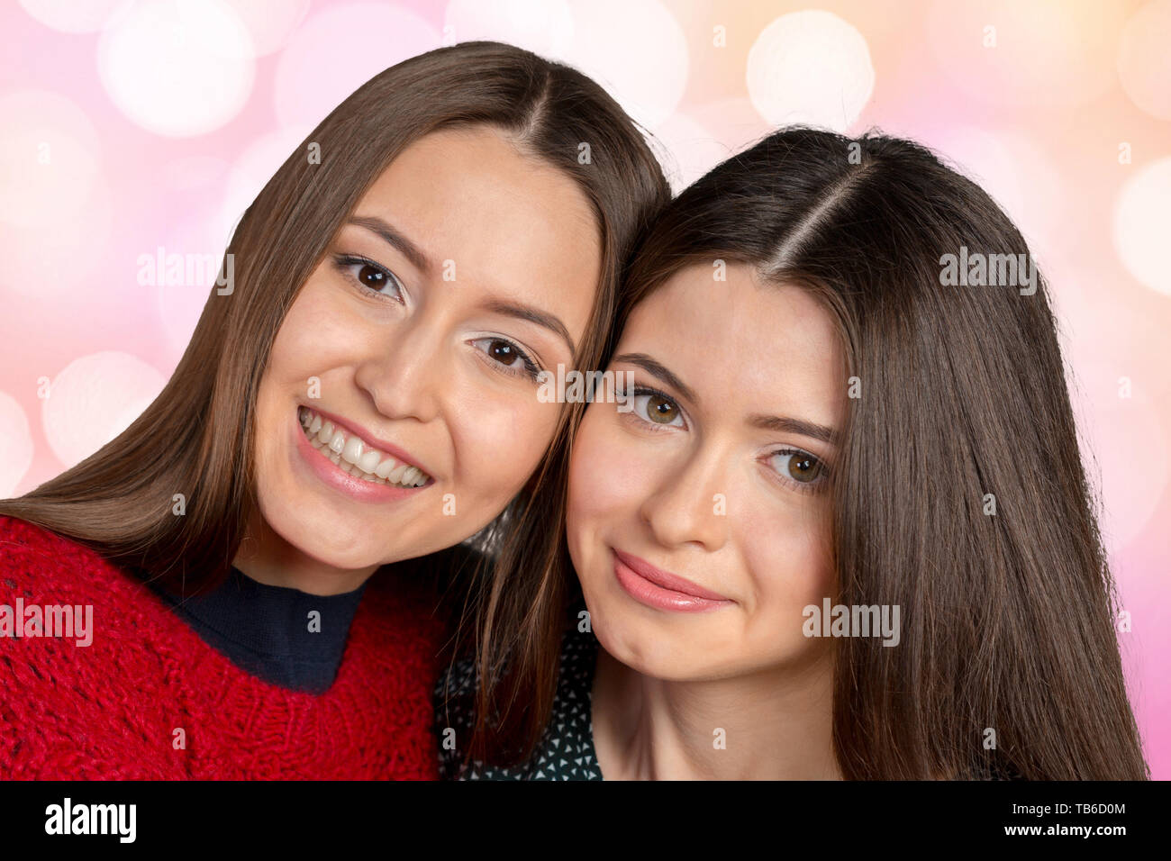 Two beautiful sisters hugging each other and smiling Stock Photo - Alamy