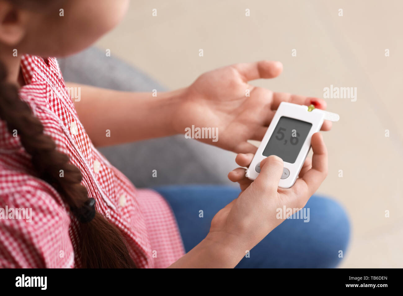 Diabetic girl with digital glucometer at home Stock Photo - Alamy