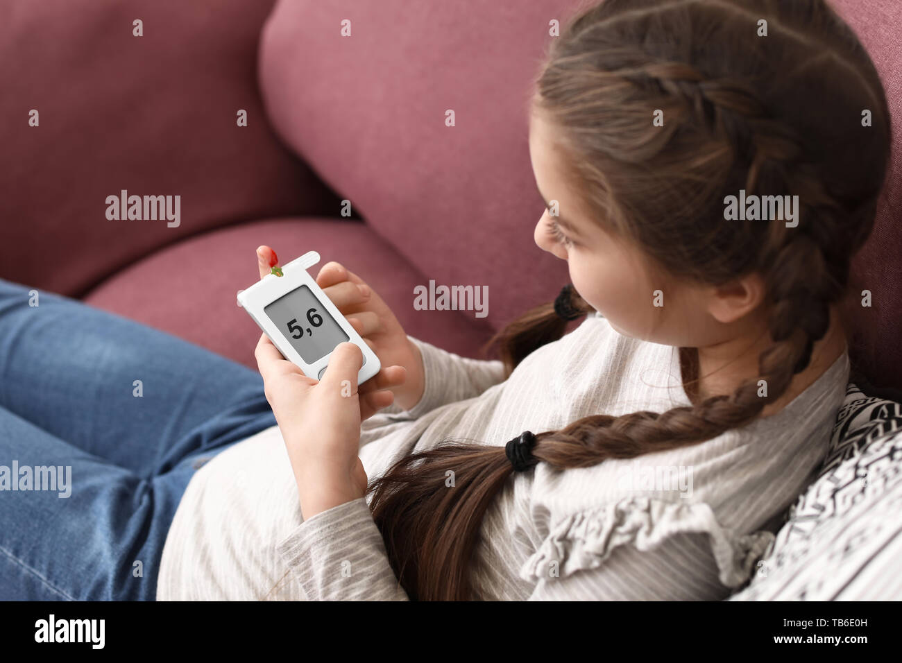 Diabetic girl with digital glucometer at home Stock Photo - Alamy