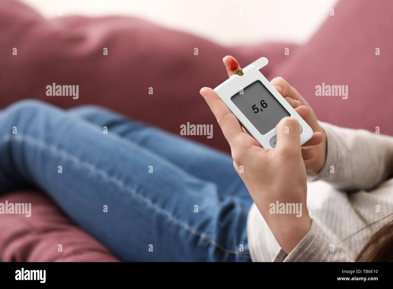 Diabetic girl with digital glucometer at home, closeup Stock Photo - Alamy