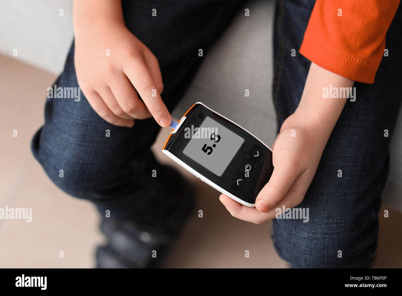 Diabetic child with digital glucometer at home, closeup Stock Photo - Alamy