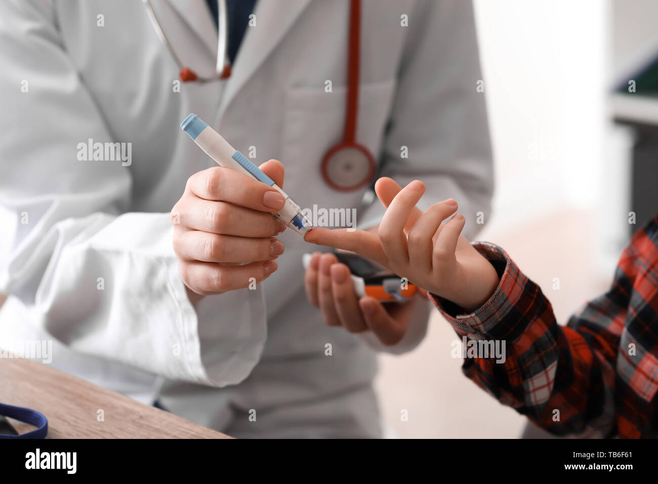 Doctor taking blood sample of diabetic child in clinic Stock Photo - Alamy