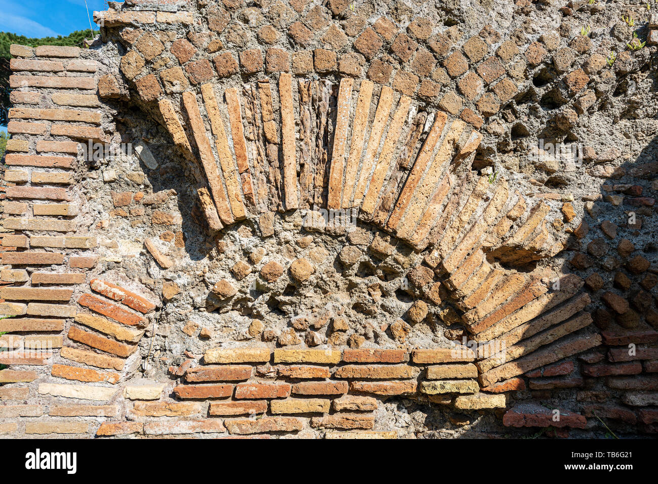 Old ruins of a Roman building with a brick wall and arch. Ostia Antica ...
