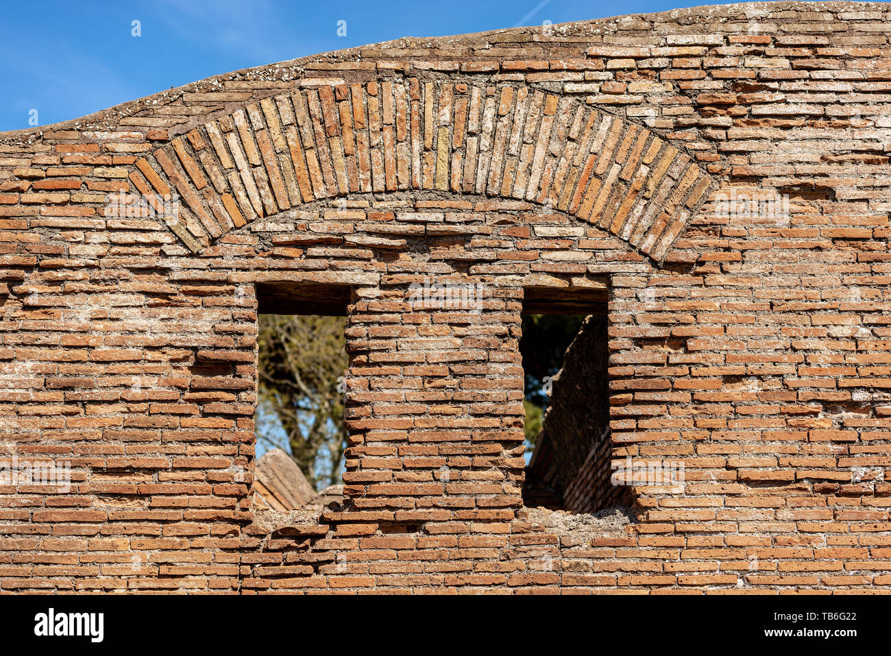 Old ruins of a Roman building with a brick wall and windows. Ostia ...