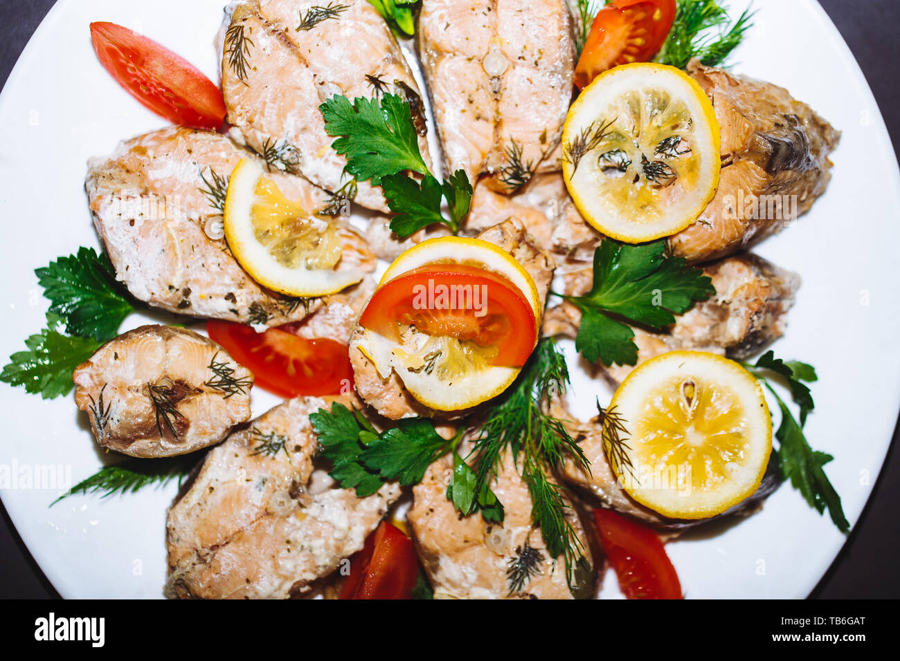 Baked salmon fish fillet with tomatoes,spices. Diet menu. Top view ...