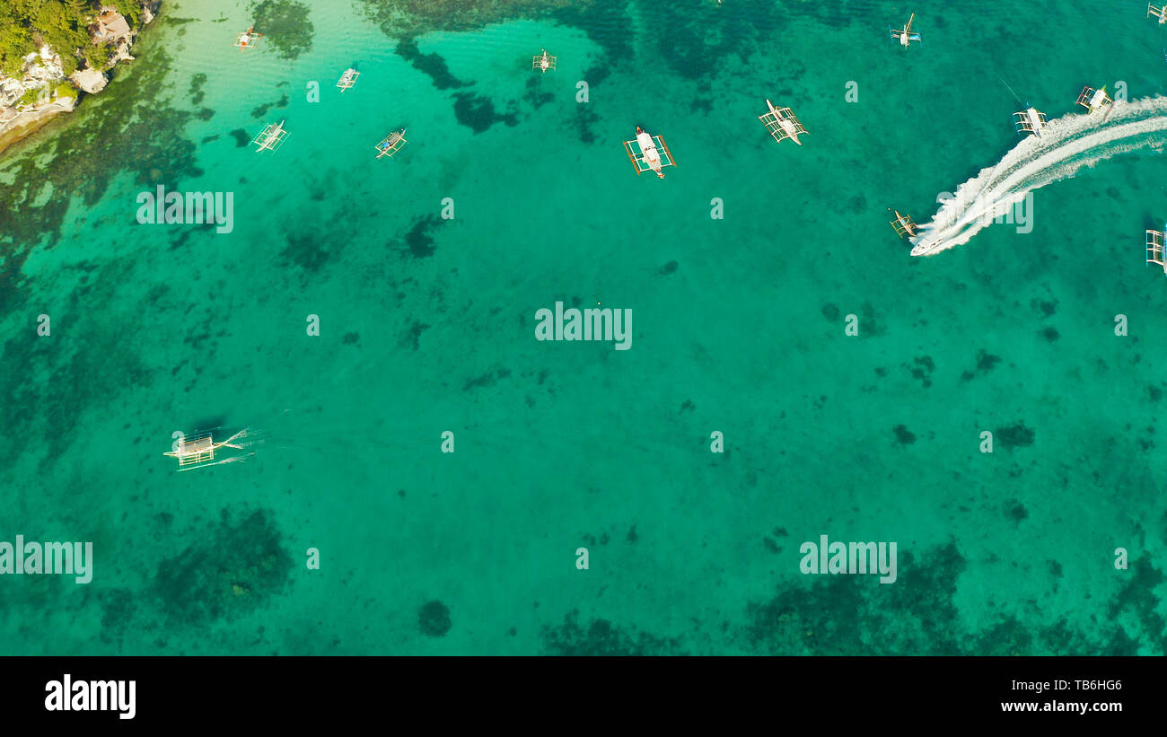 Tropical landscape boats in the turquoise lagoon and tropical beach ...