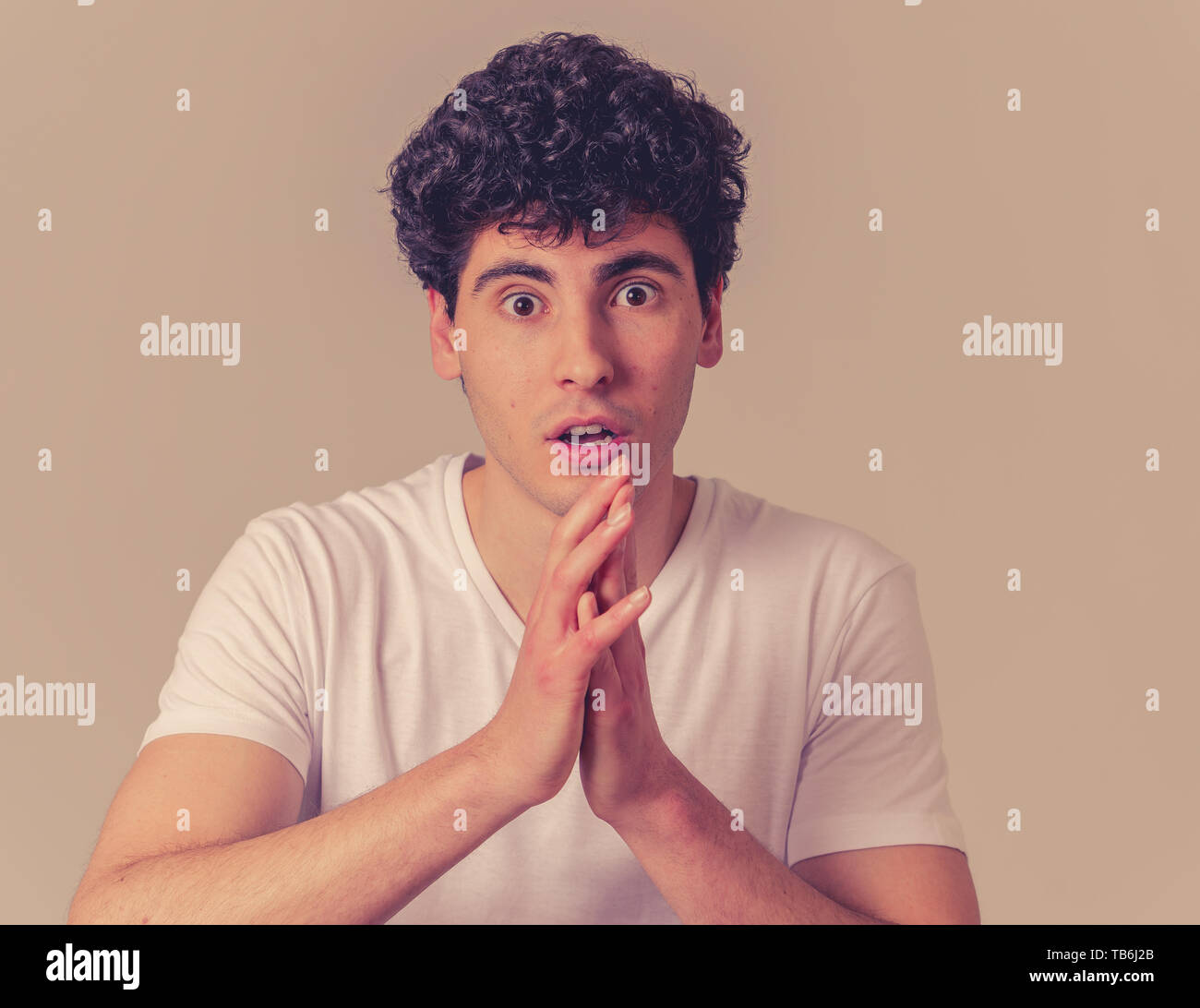 Portrait of handsome shocked young man hearing unexpected news ...