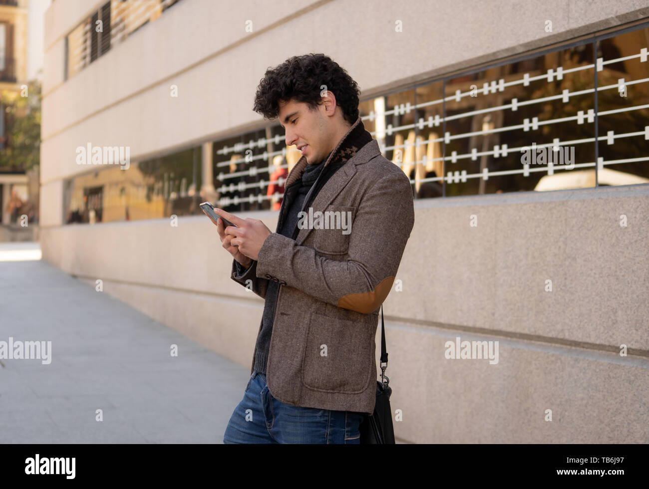 Fashion college man in his twenties happy checking blog or chatting on ...
