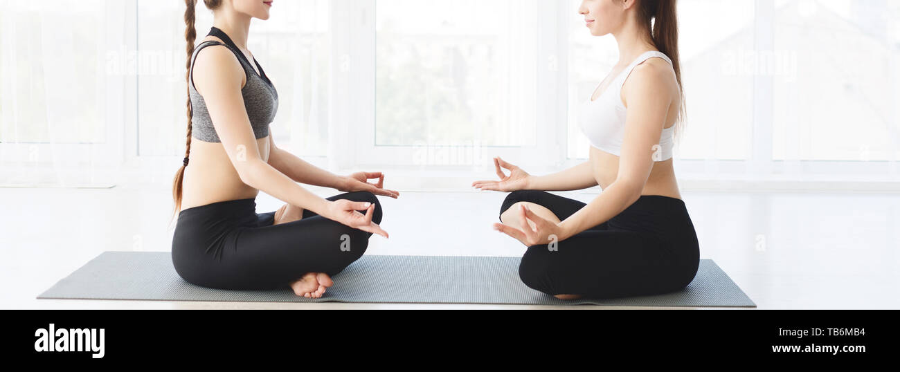 Two girls sitting opposite each other hi-res stock photography and ...