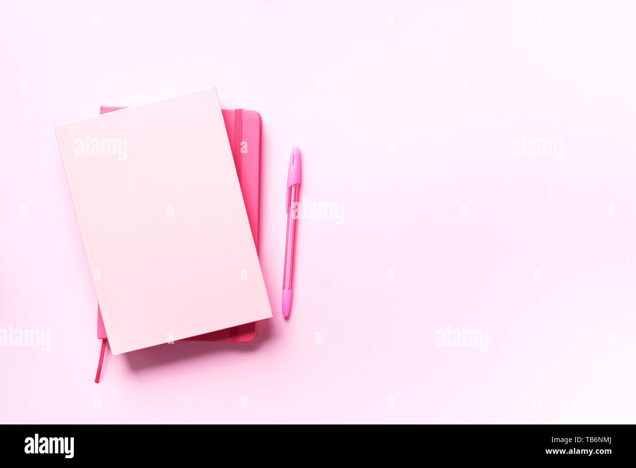 Top view of open pink notebook on pastel colorful background. Copy ...