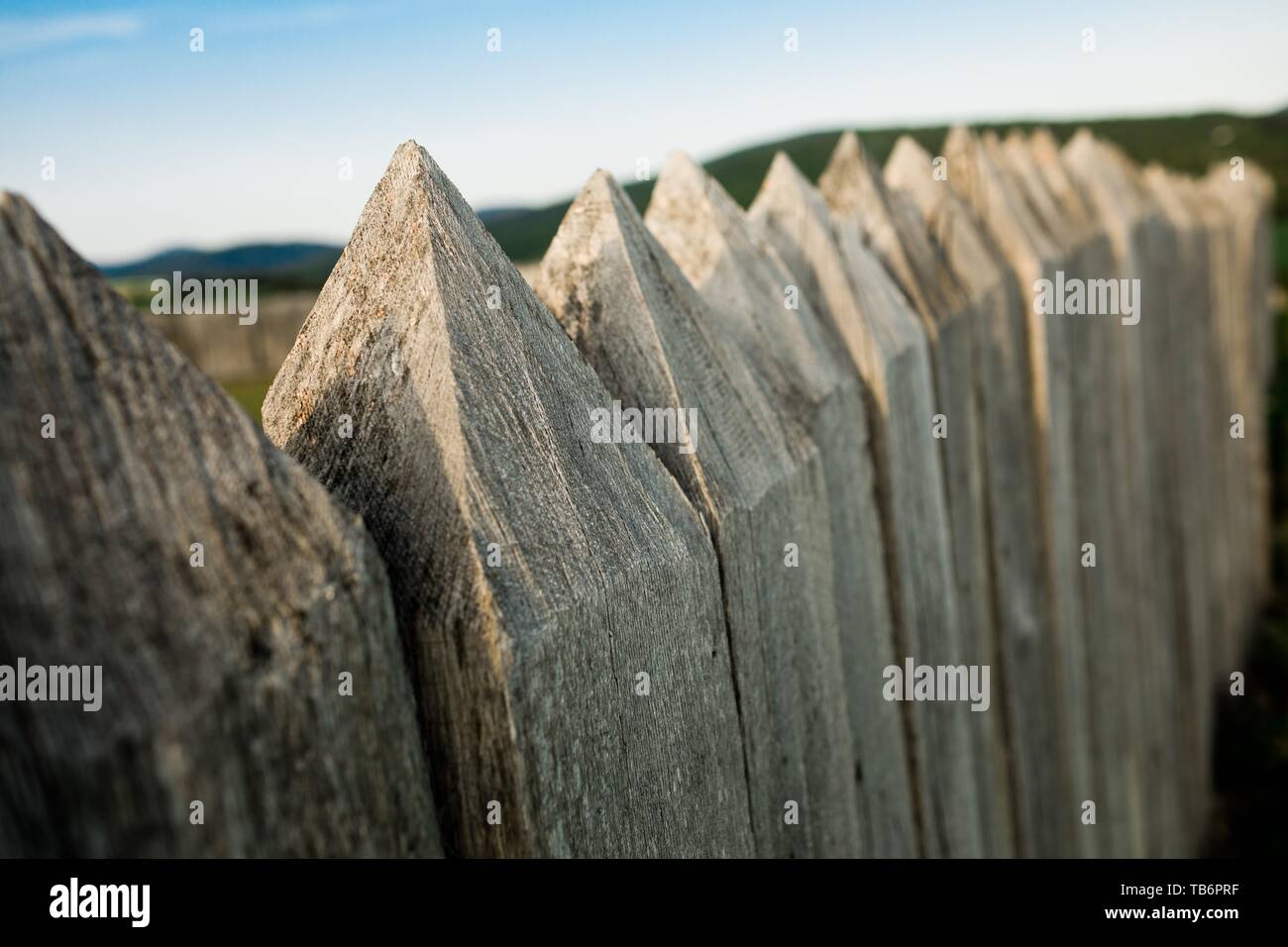 Wooden defense fence, ancient historic place surrounded with spiked ...