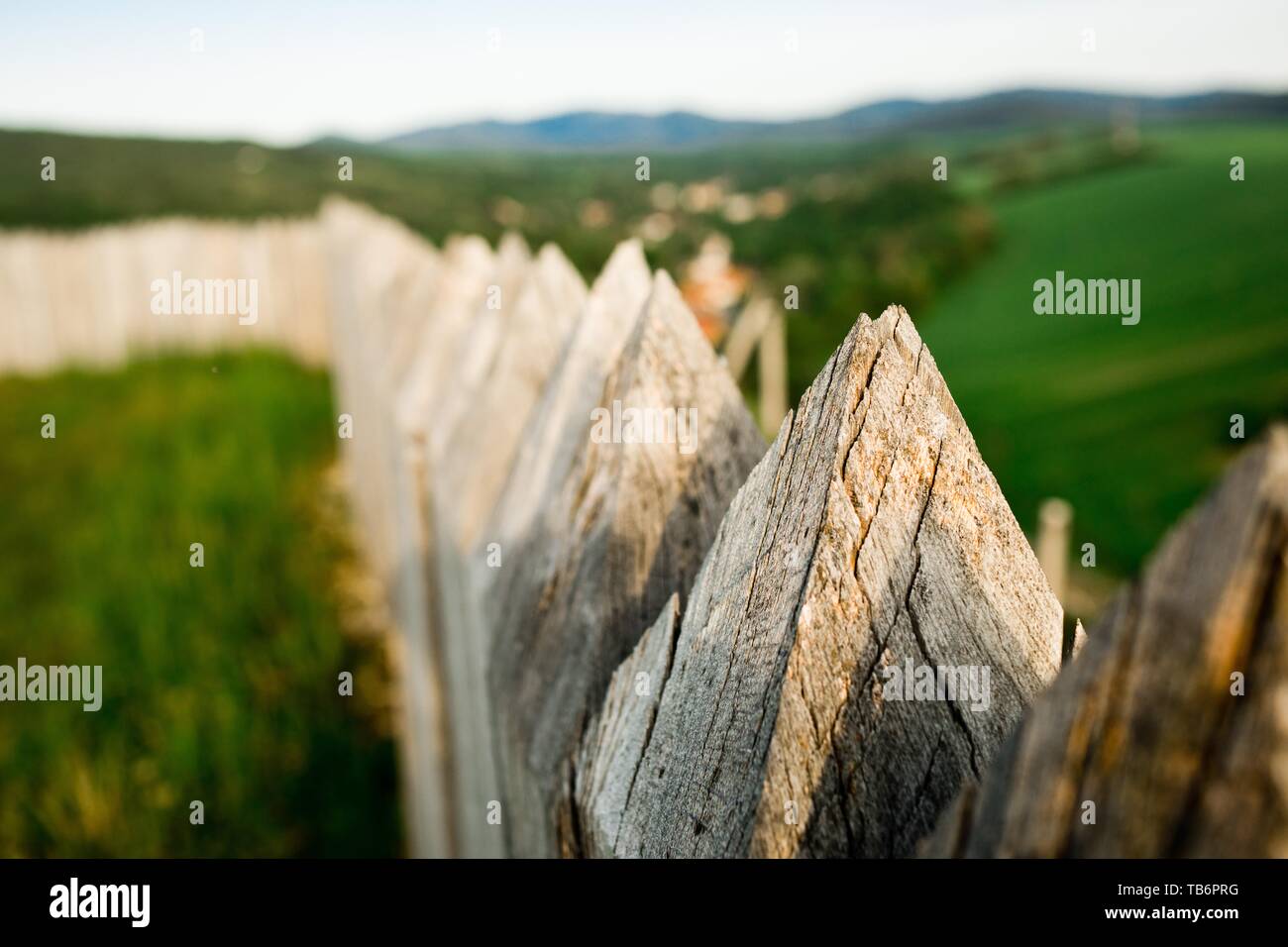Wooden defense fence, ancient historic place surrounded with spiked ...