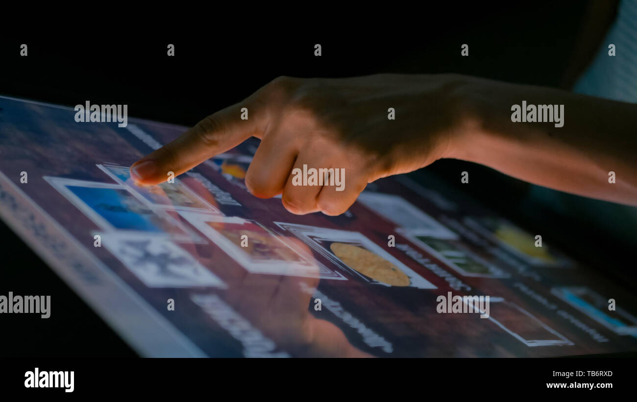 Woman using interactive touchscreen display Stock Photo - Alamy
