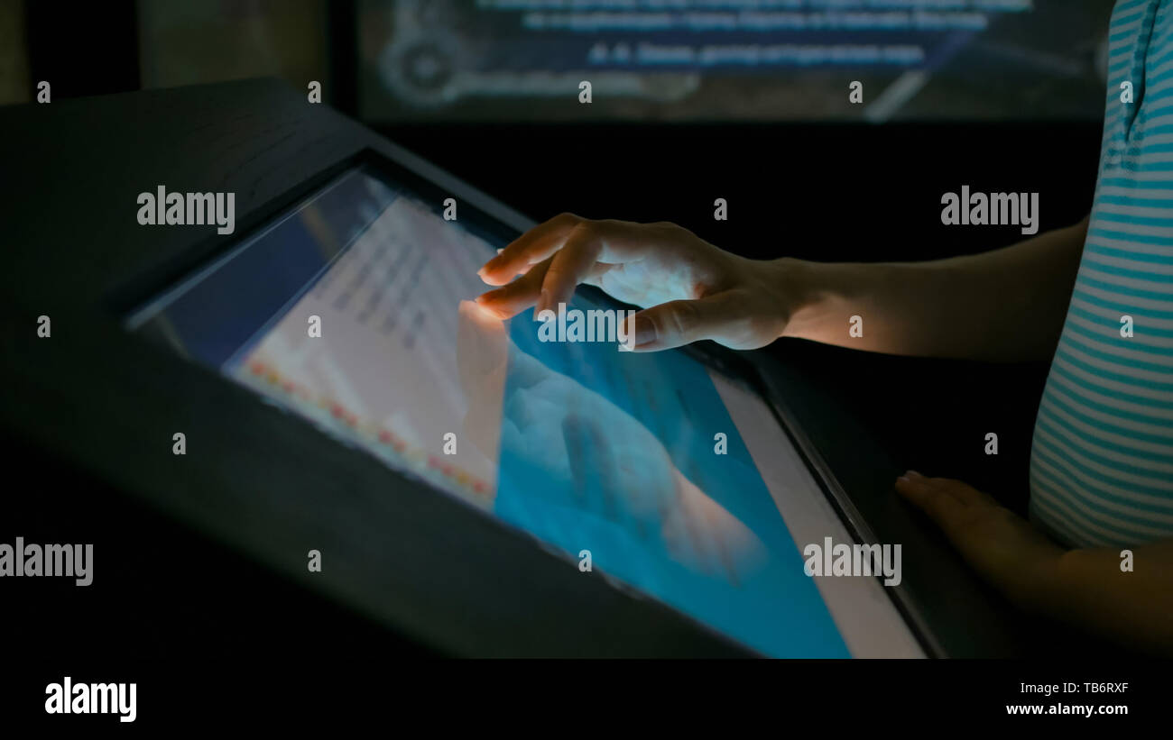 Woman using interactive touchscreen display Stock Photo - Alamy