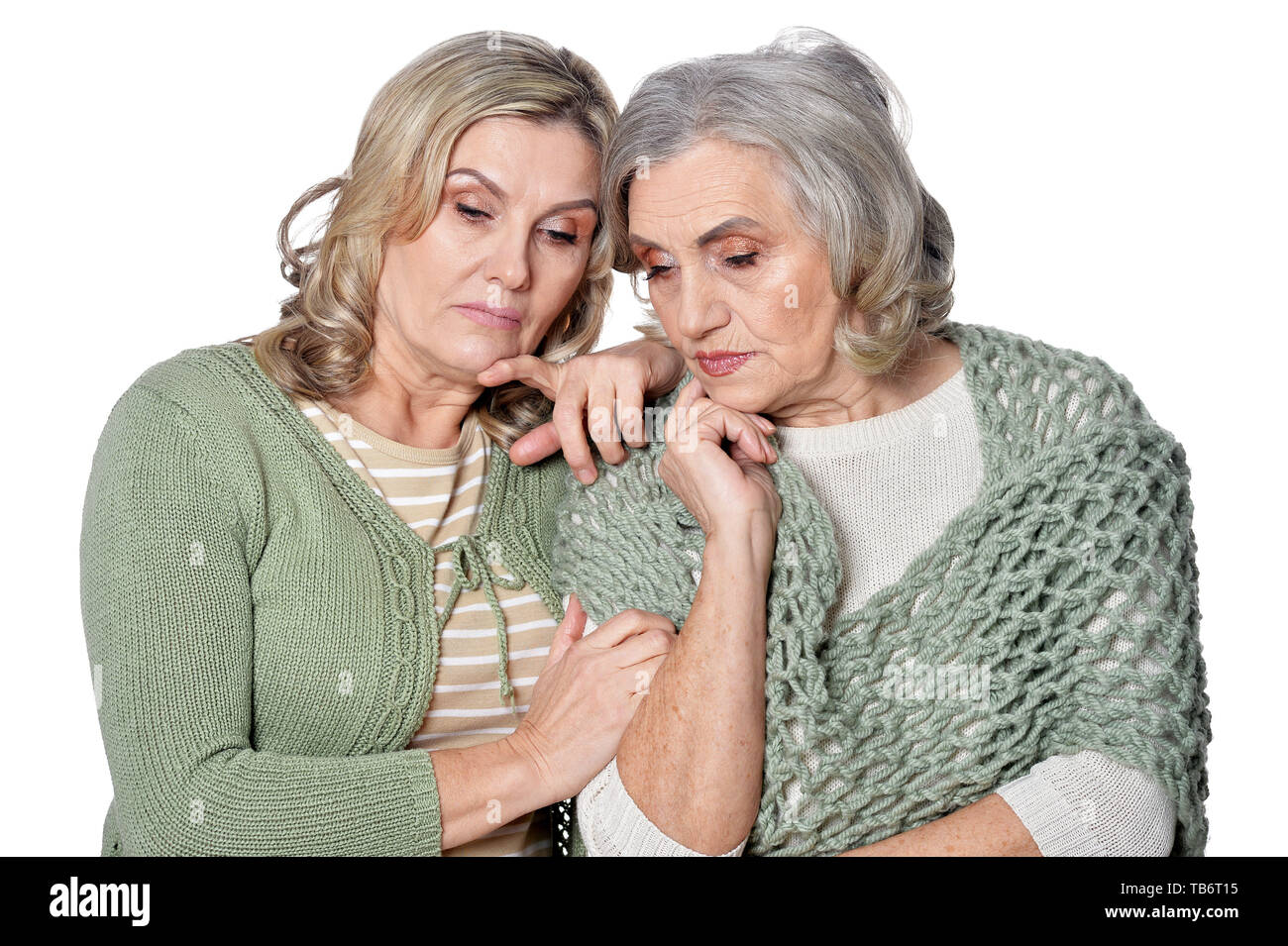 Portrait of two sad women on white background Stock Photo - Alamy