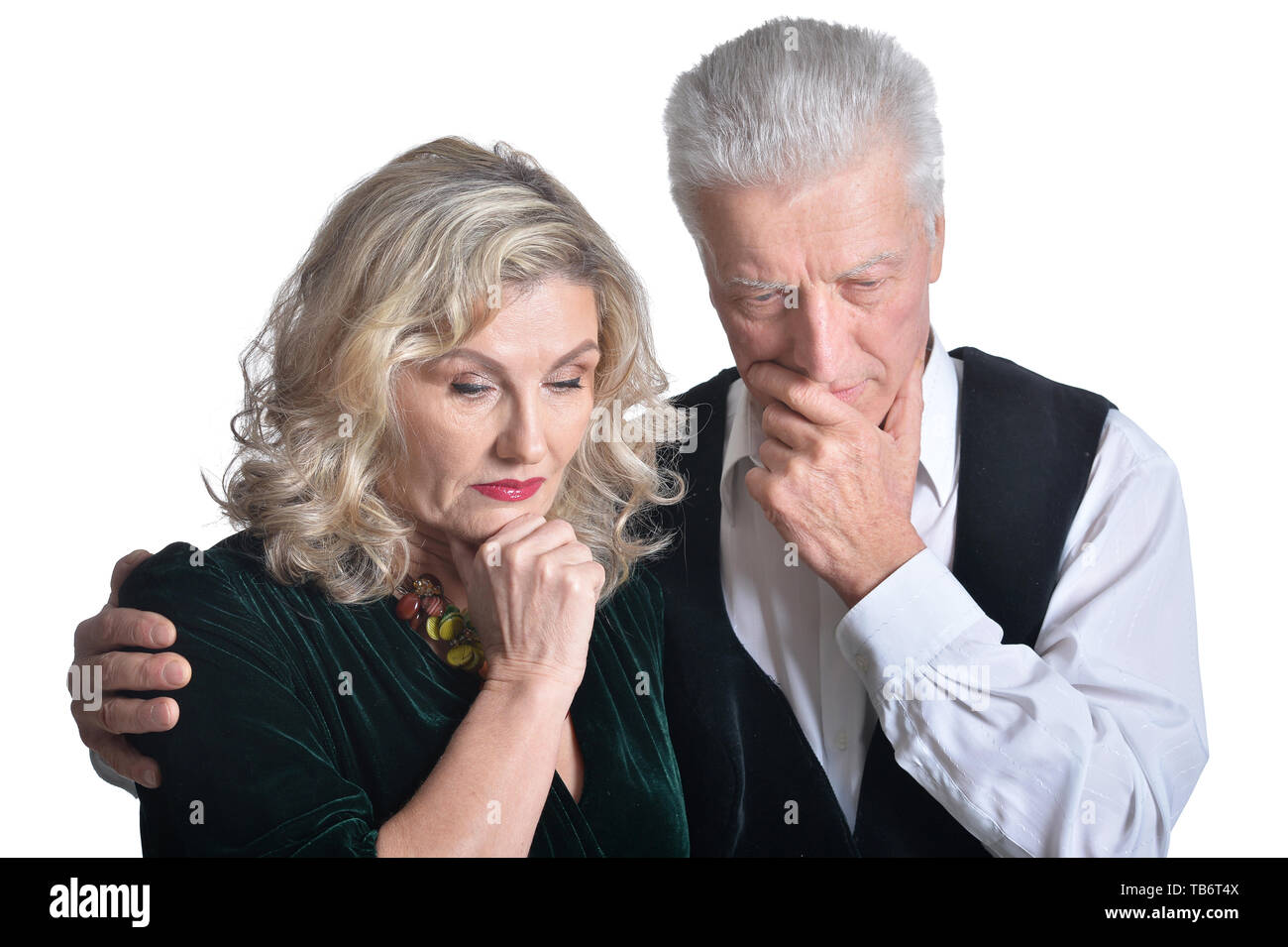 Portrait of sad senior couple hugging on white background Stock Photo ...