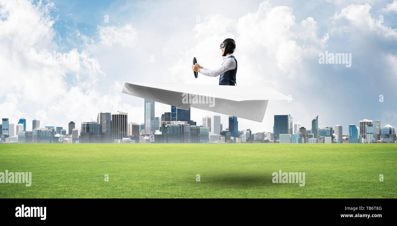 Young pilot sitting in big paper plane Stock Photo - Alamy