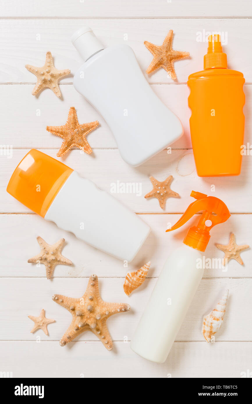flat lay concept summer travel vacation. Sunscreen bottles with ...
