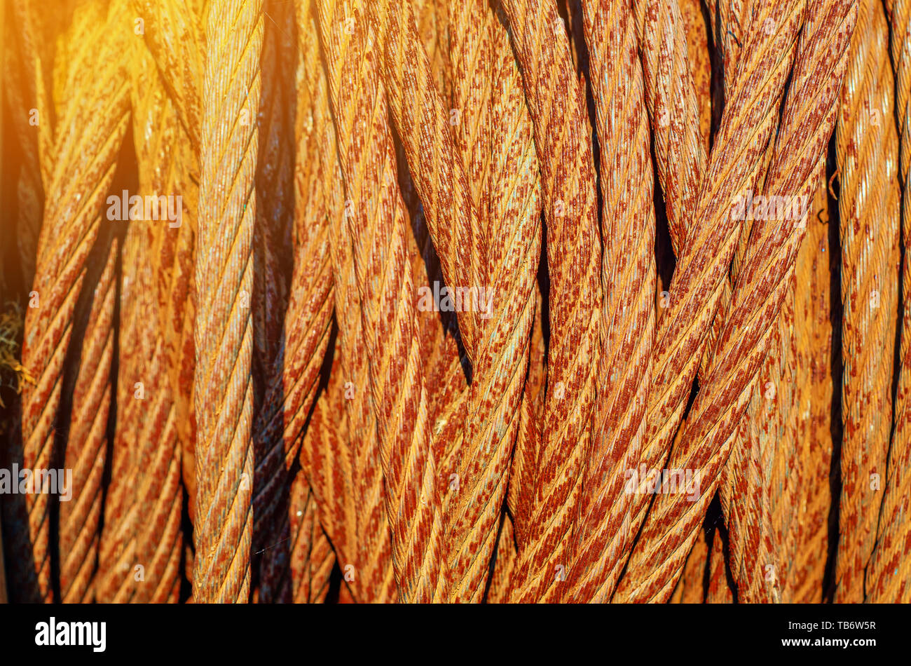 Rusty metal rope wound on a reel. Vintage metal background Stock Photo ...