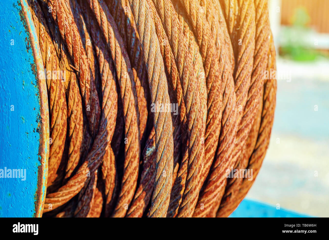 Rusty metal rope wound on a reel. Vintage metal background Stock Photo ...