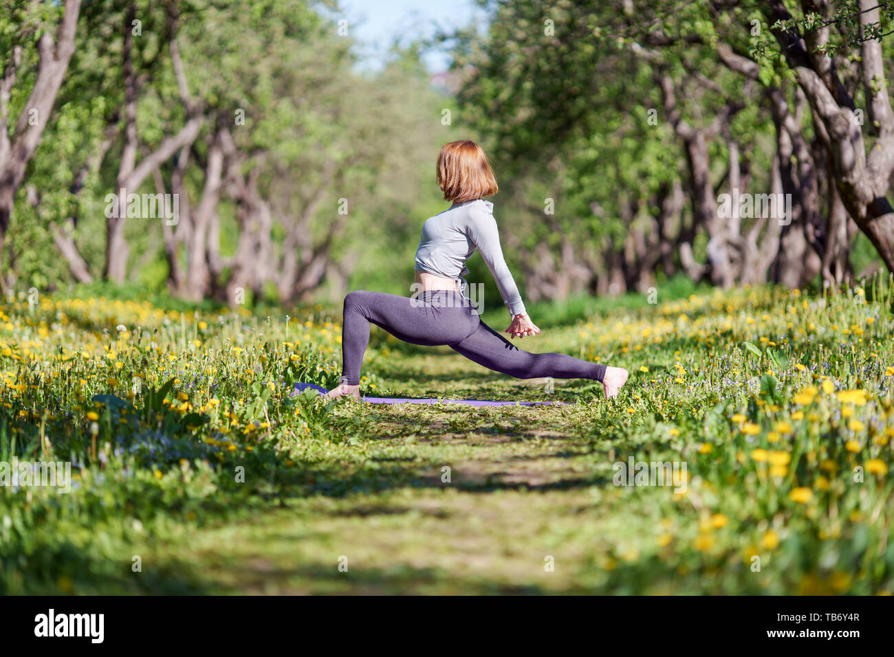 Photo of woman practicing yoga in forest in afternoon Stock Photo - Alamy