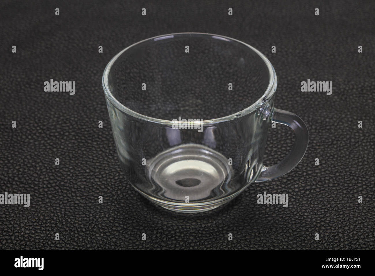 Empty glass cup over black background Stock Photo - Alamy
