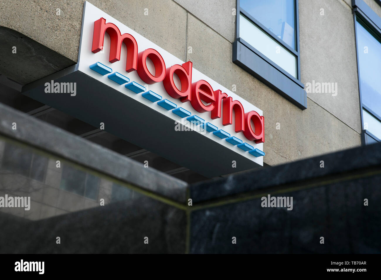 A logo sign outside of the headquarters of Moderna Therapeutics in ...